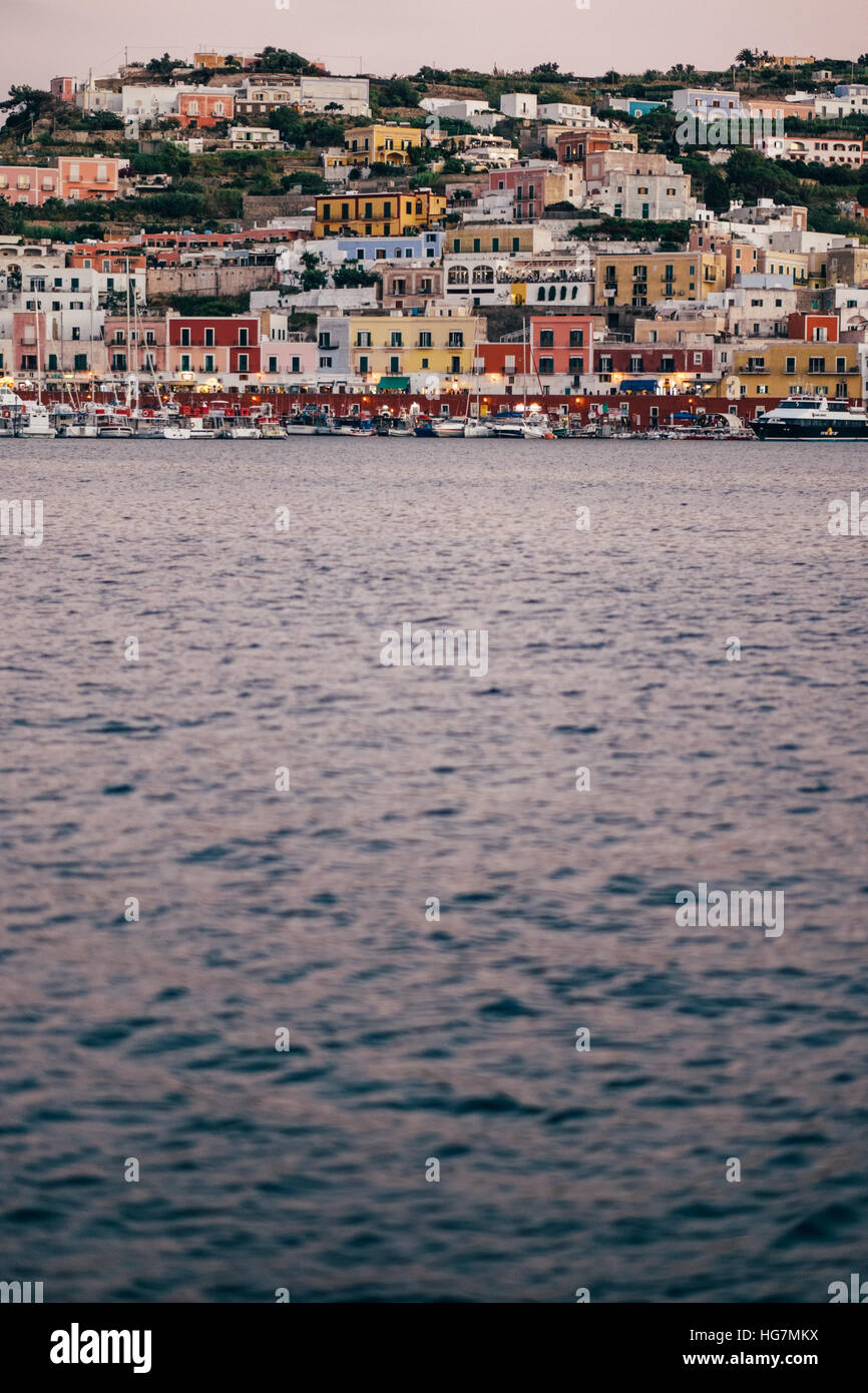 A view of the port town of Ponza, Italy at dusk, just after the sun has ...