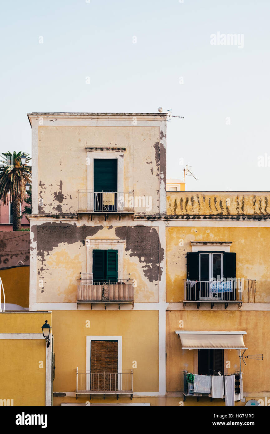 A worn, old yellow building on the island of Ventotene, Italy Stock ...