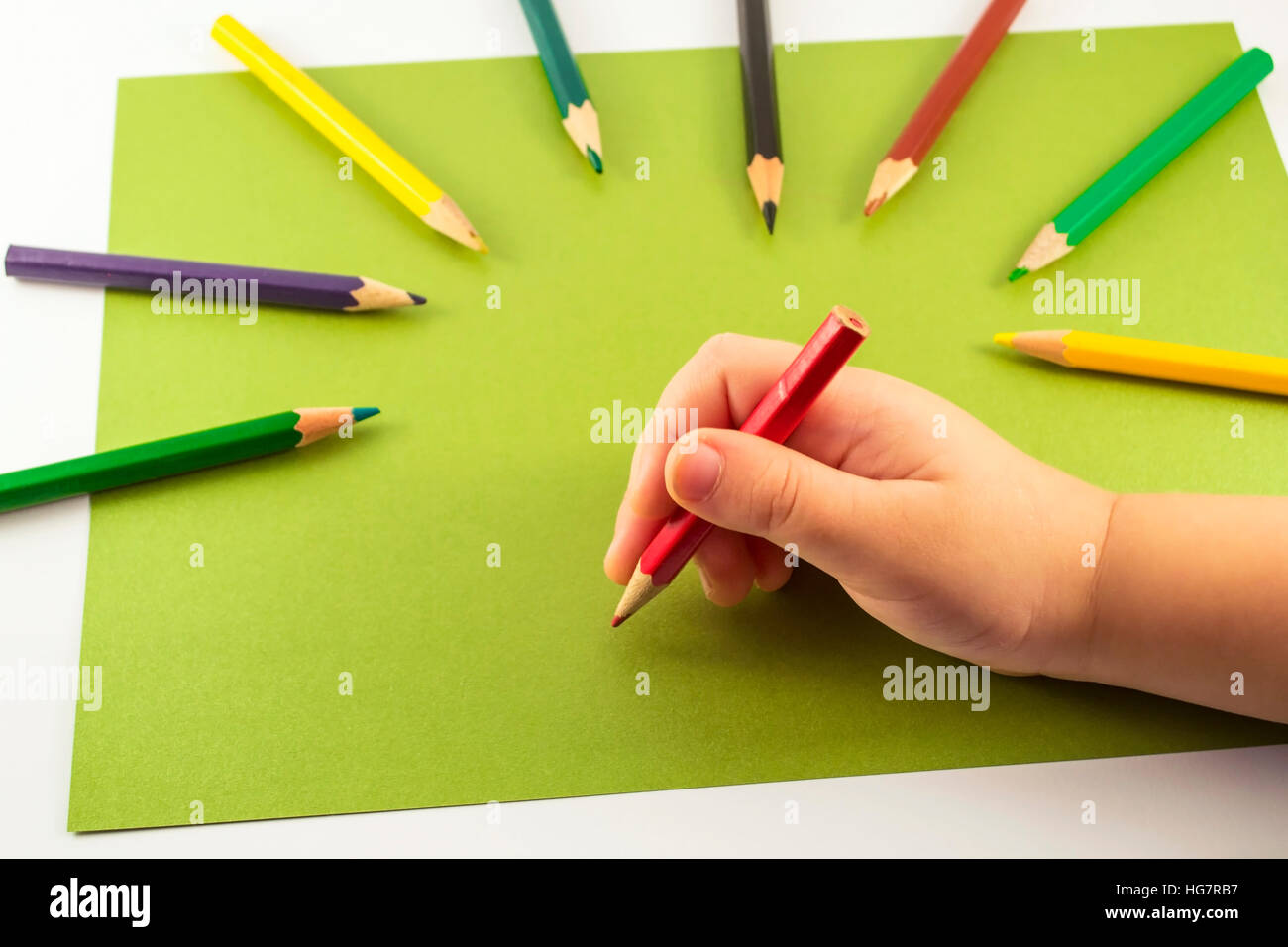 Kids hand holding a red pencil Stock Photo - Alamy