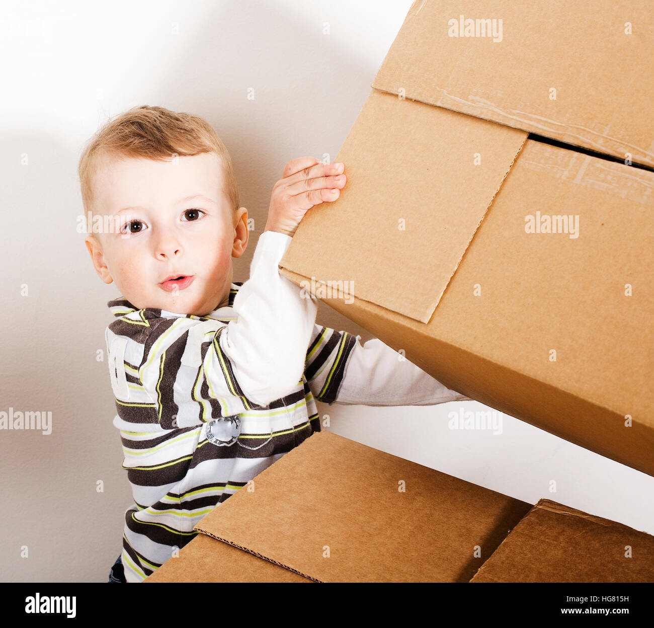 portrait of little cute boy playing with box, lifestyle people concept ...