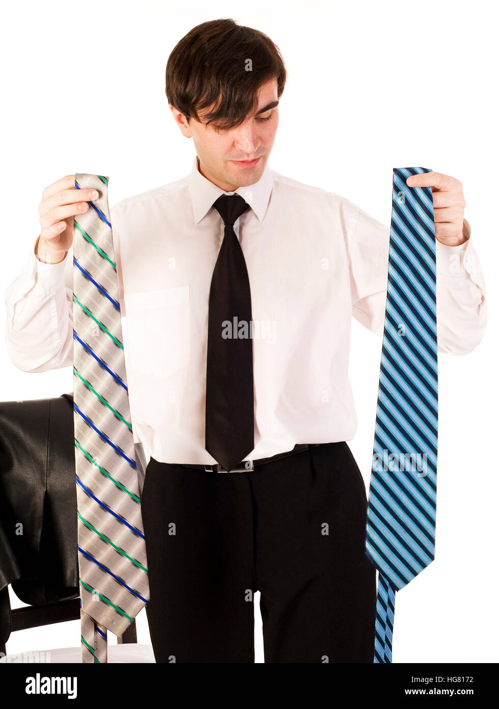young brunette handsome guy having choice between two ties isolated on ...