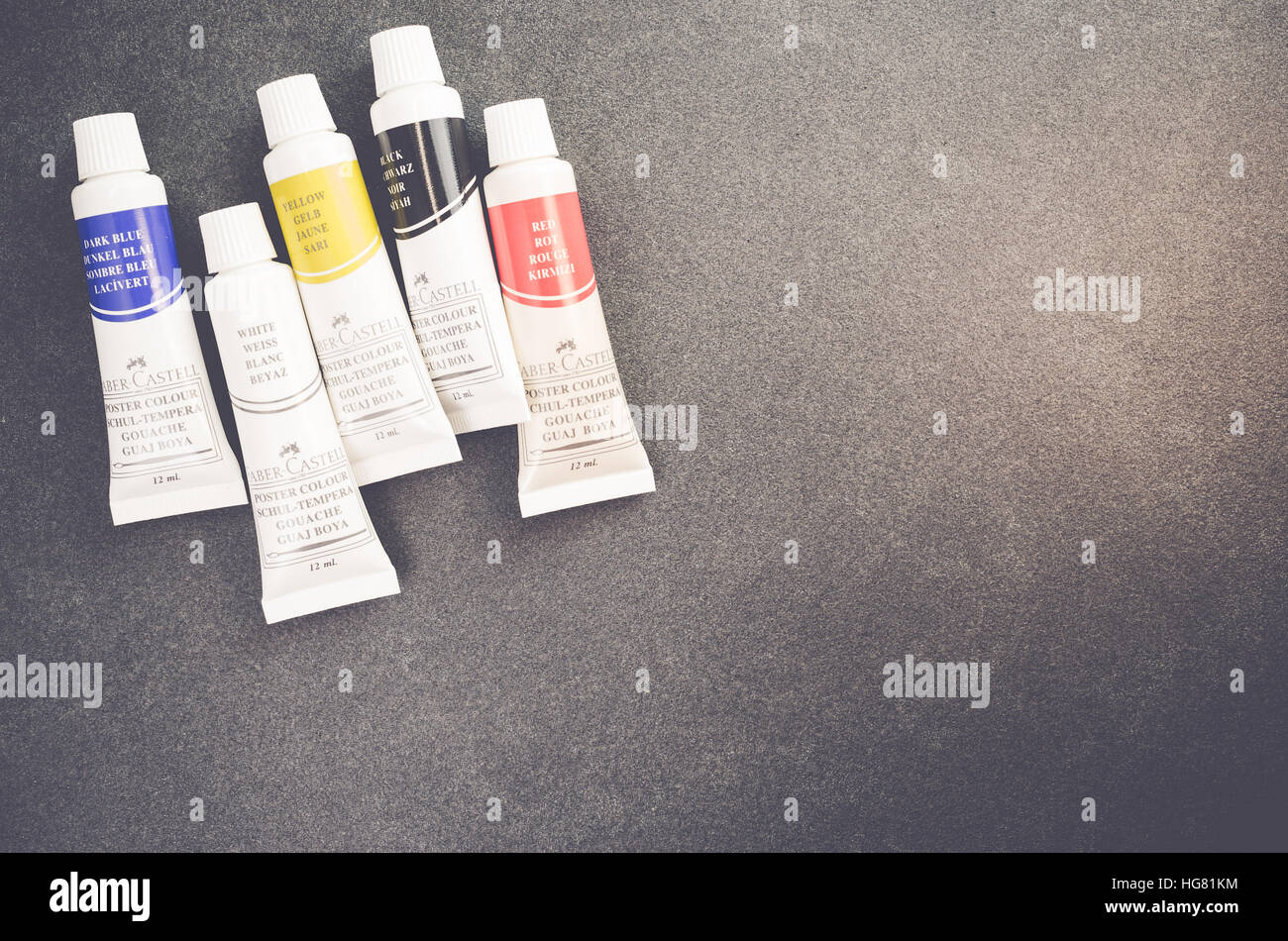 poster paint tubes on a dark slate worktop - top view Stock Photo - Alamy