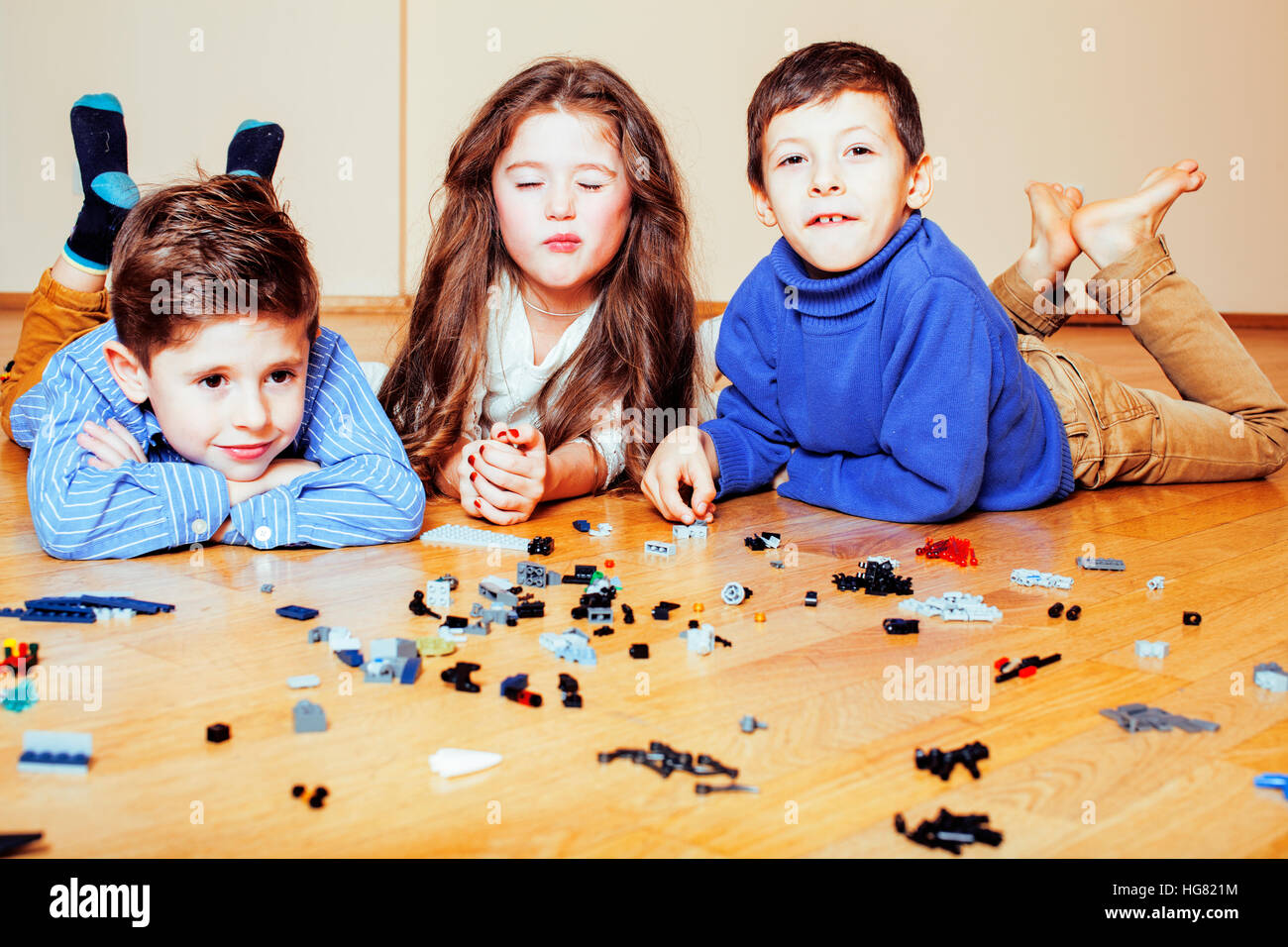 funny cute children playing lego at home, boys and girl smiling, first ...