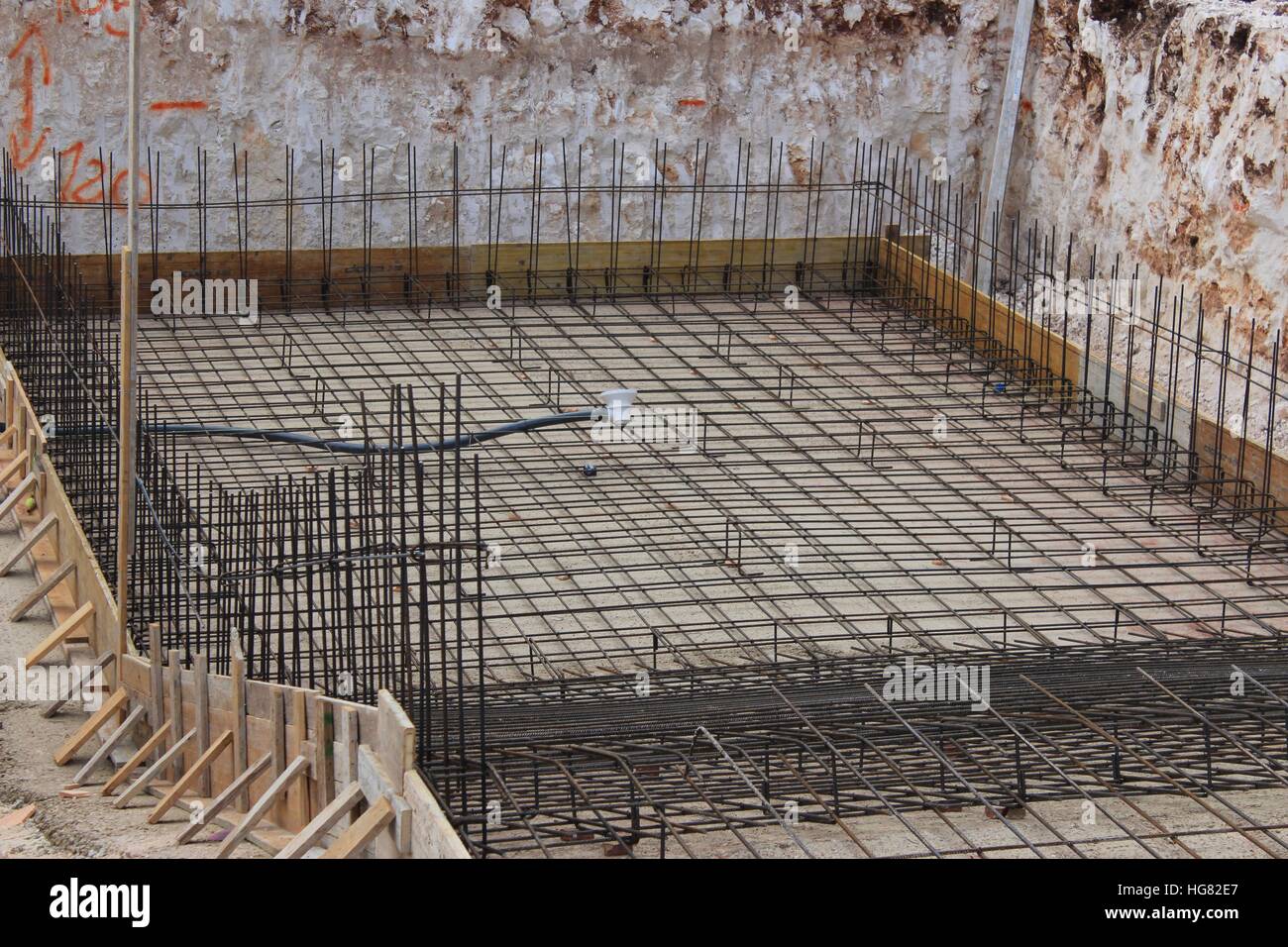 In-ground swimming pool under construction, with steel reinforcing rods ...