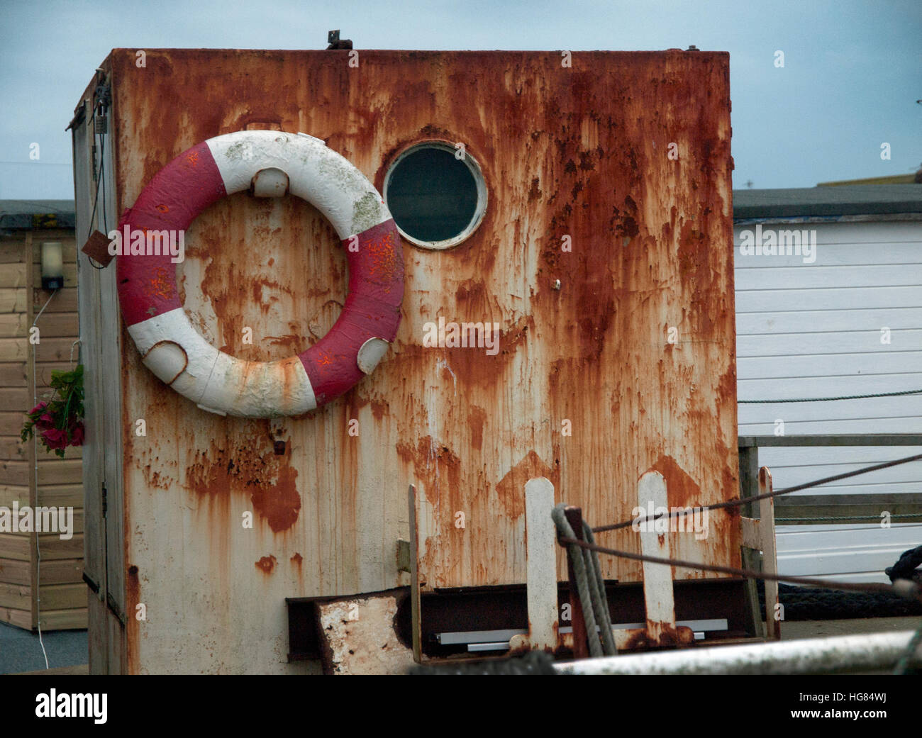 A lifebuoy secured to a rusty section of a houseboat Stock Photo - Alamy