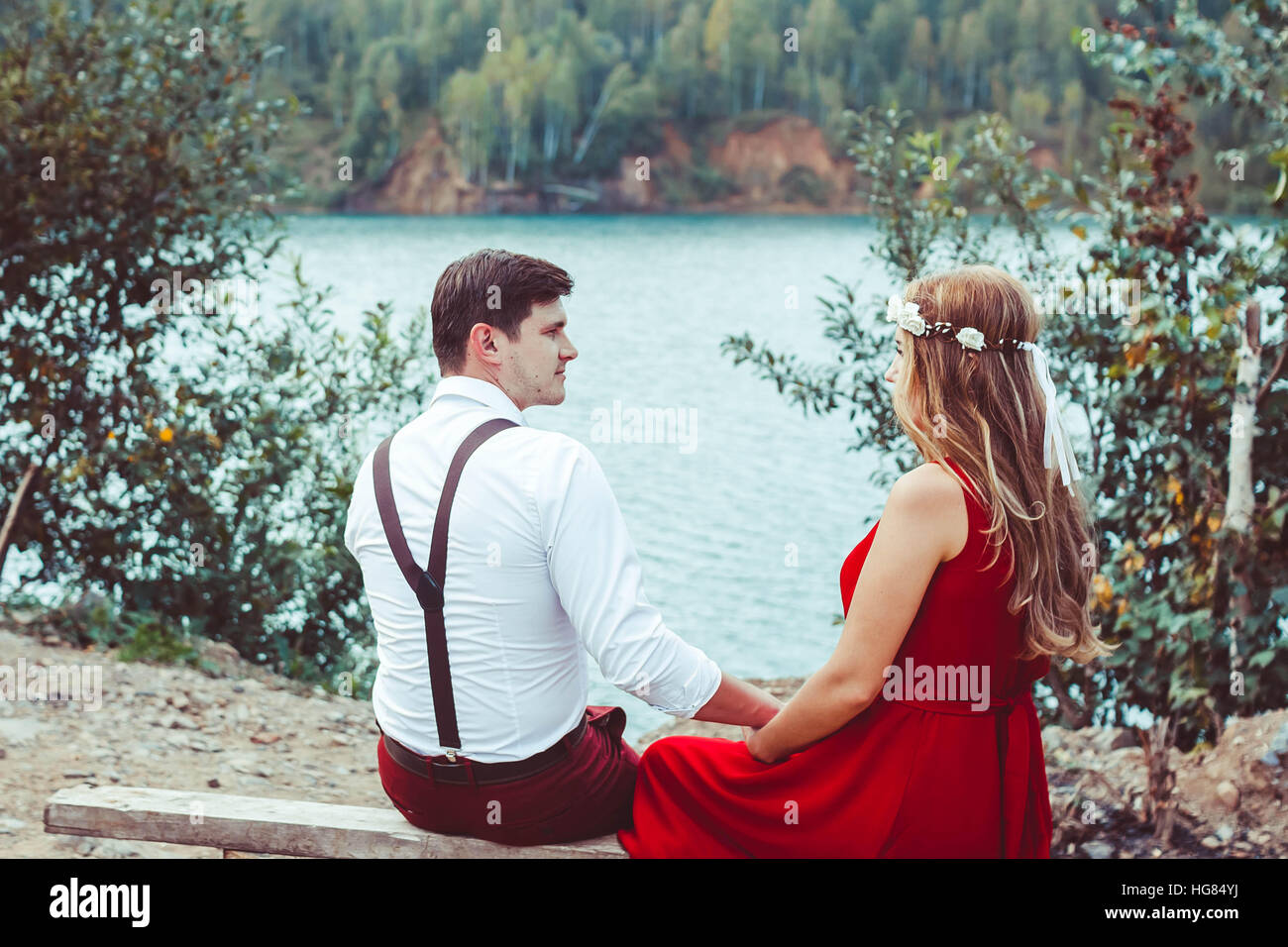 lovers sitting by the water on the bench Stock Photo - Alamy
