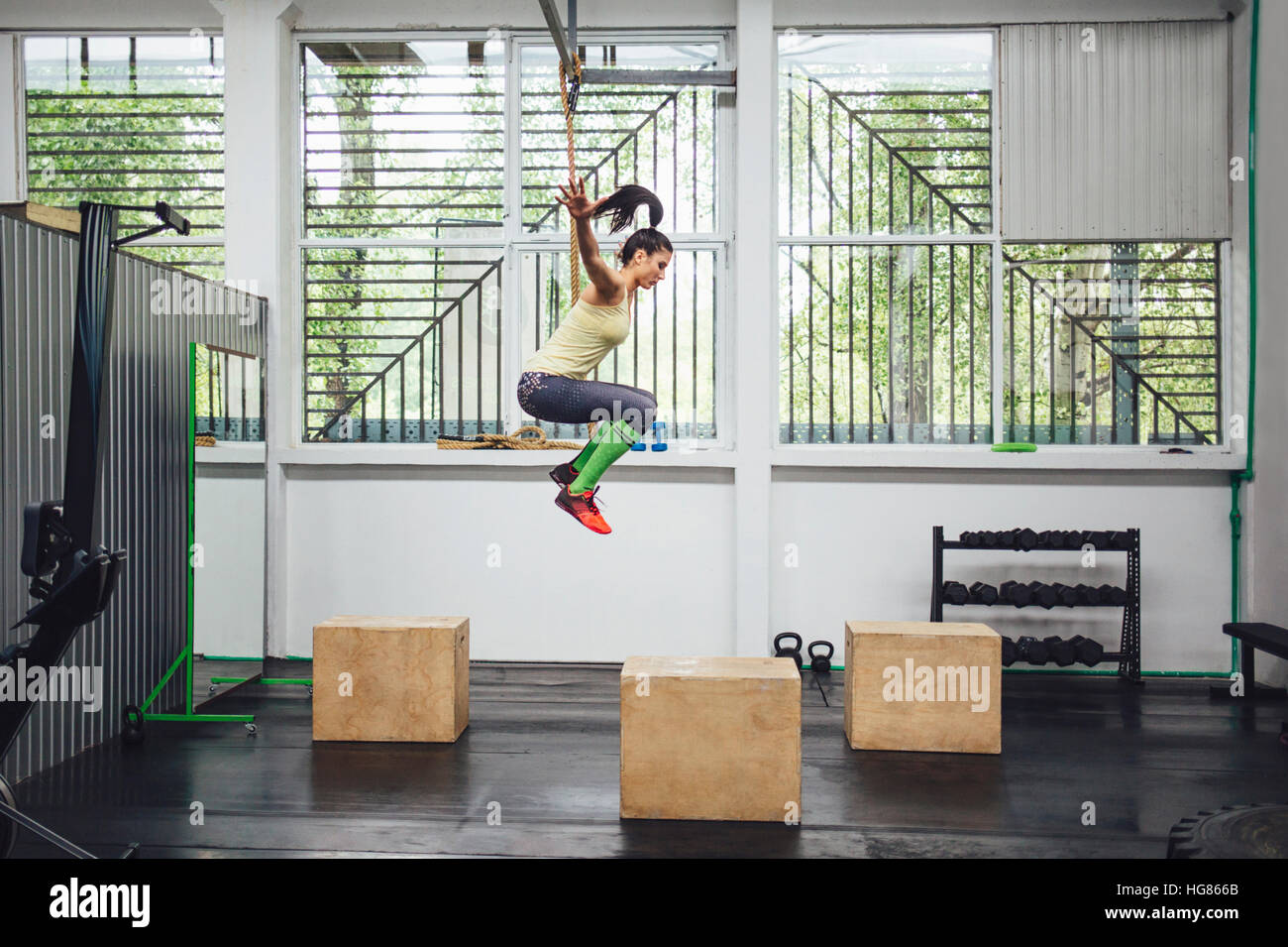 Woman jumping in gym Stock Photo - Alamy