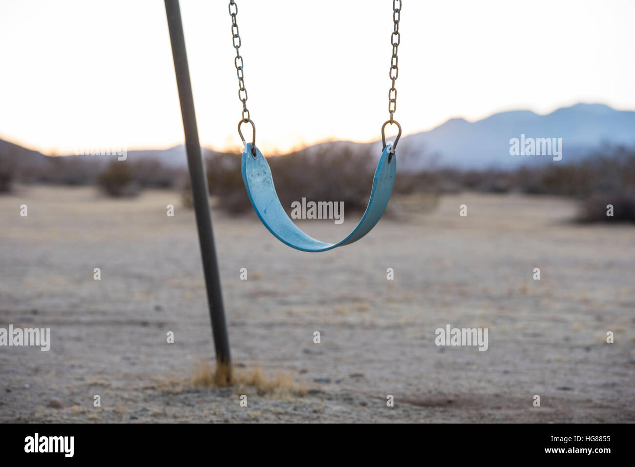 Chain swing on field Stock Photo - Alamy