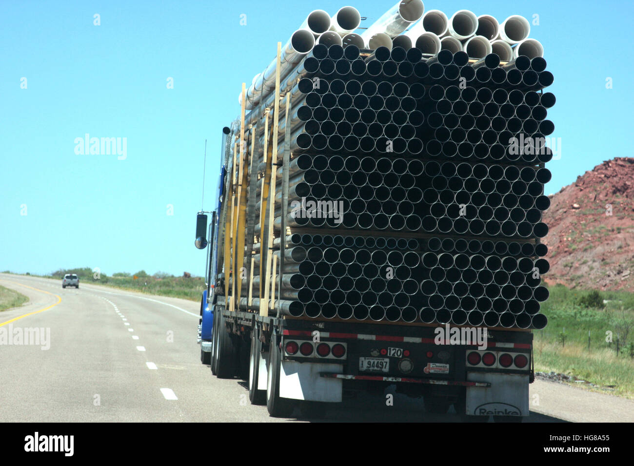 Truck on highway loaded with long metal pipes Stock Photo - Alamy