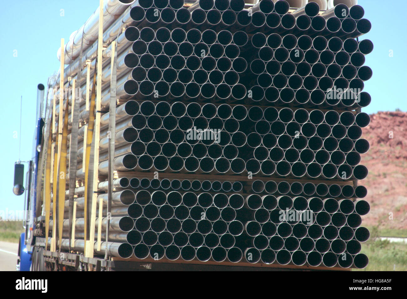 Truck on highway loaded with long metal pipes Stock Photo - Alamy
