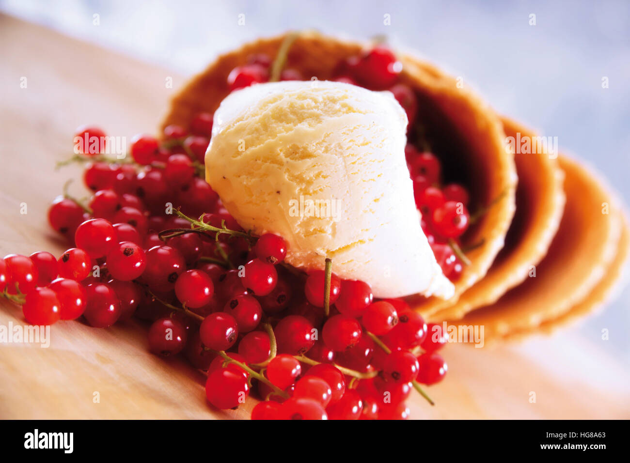 Waffle cones filled with red currants and vanilla ice cream Stock Photo ...