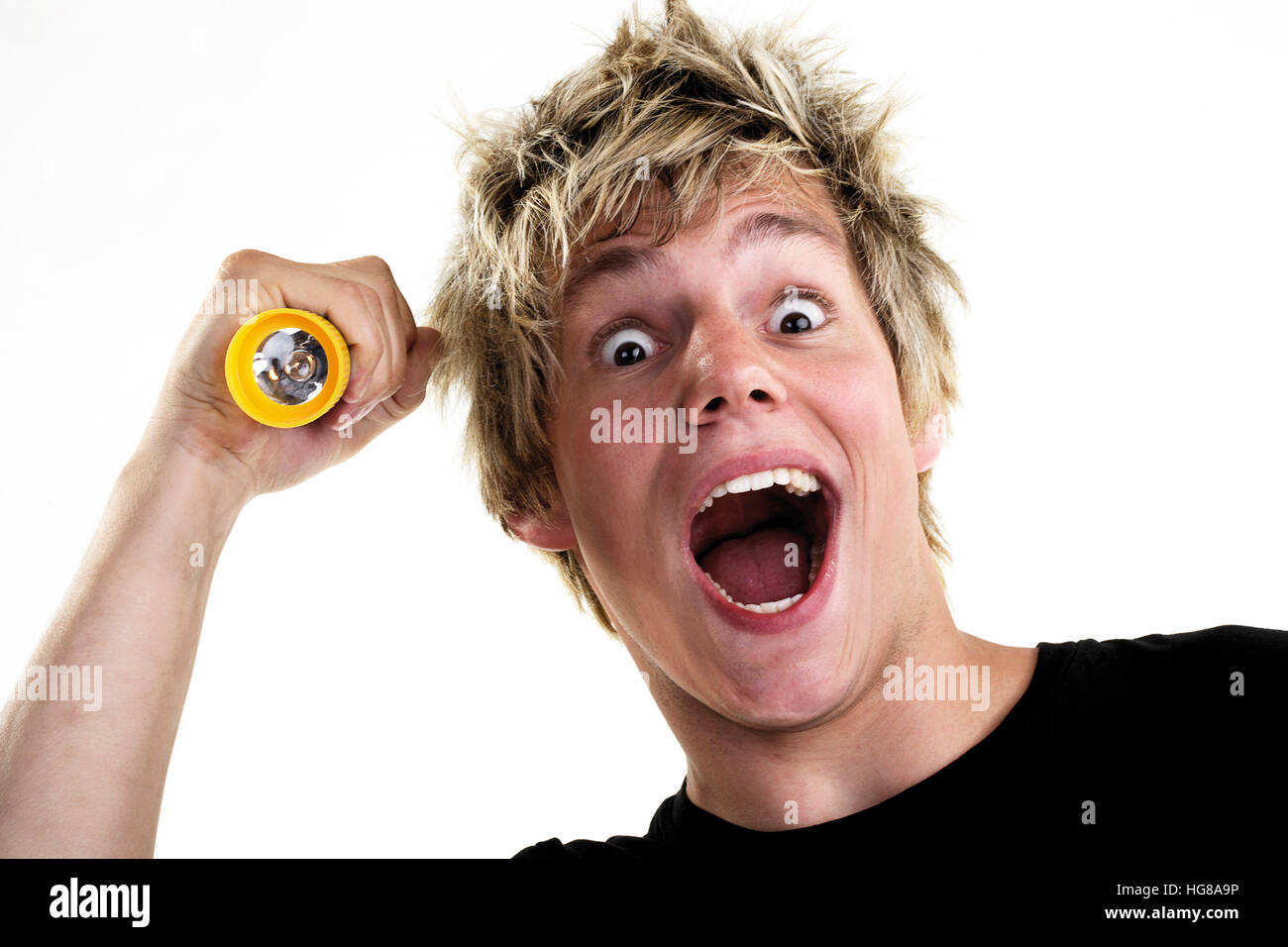 Young man holding flashlight Stock Photo - Alamy