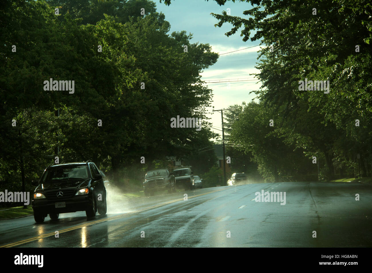 Vehicles on city road after heavy rain Stock Photo - Alamy