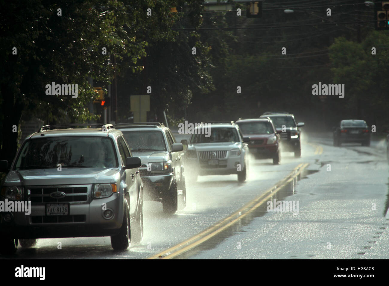 Vehicles on city road after heavy rain Stock Photo - Alamy
