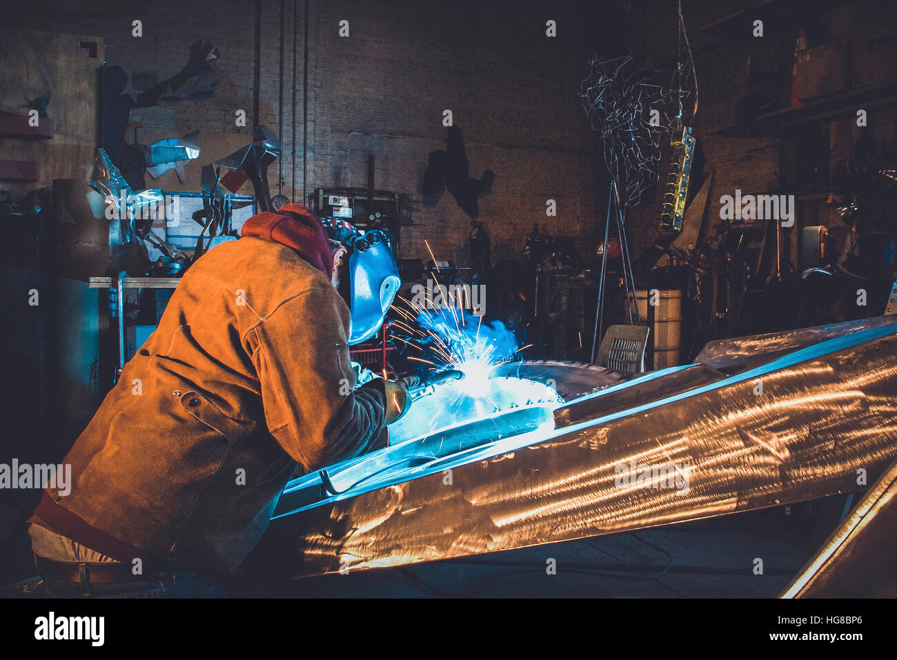 Side view of worker welding in factory Stock Photo - Alamy