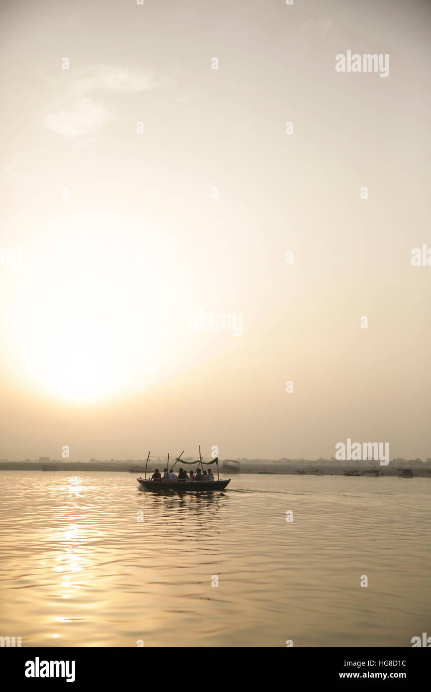 People traveling in boat during sunset Stock Photo - Alamy