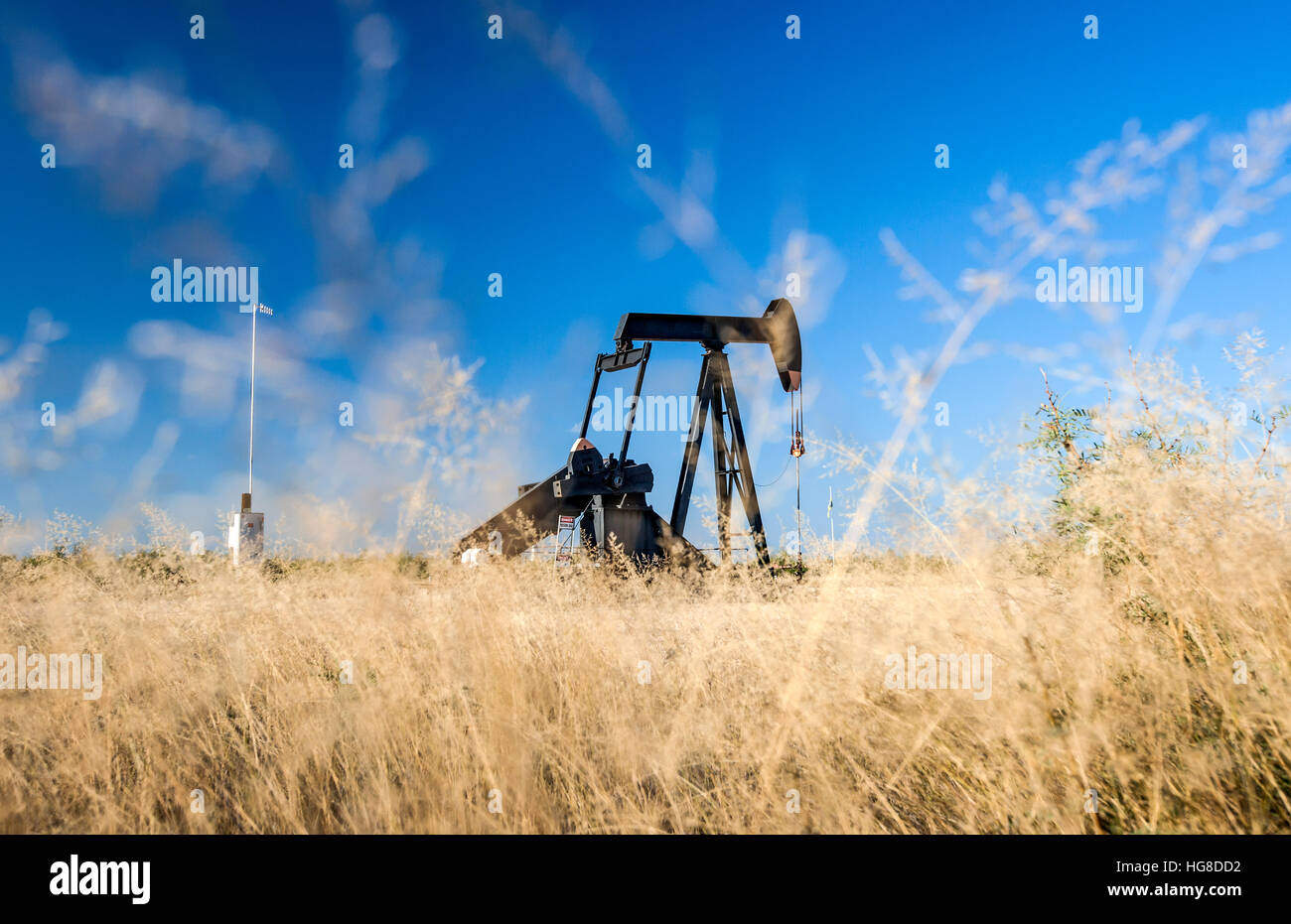 Oil pump on field against clear sky Stock Photo - Alamy