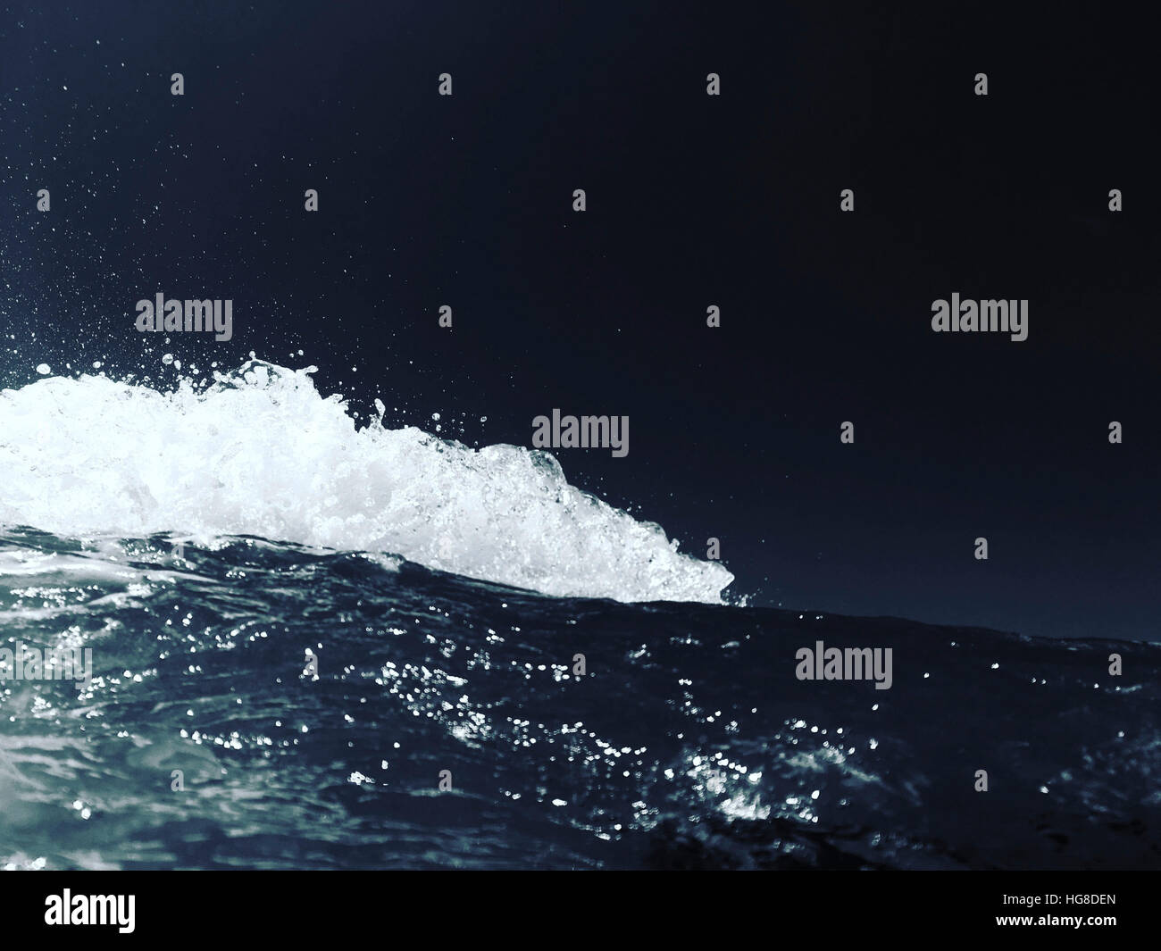 Splashing sea waves against clear sky Stock Photo - Alamy