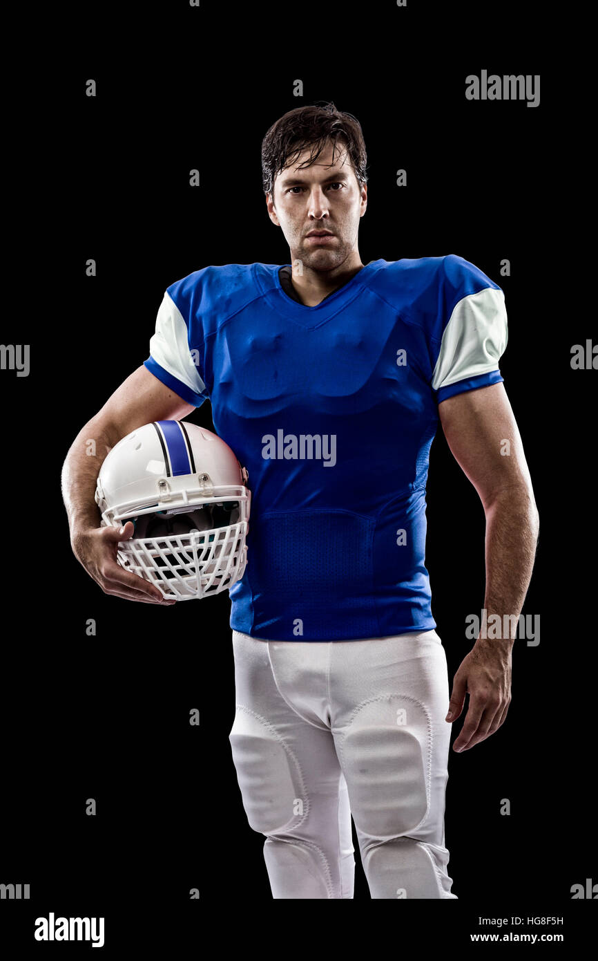 Football Player with a blue uniform on a black background Stock Photo ...