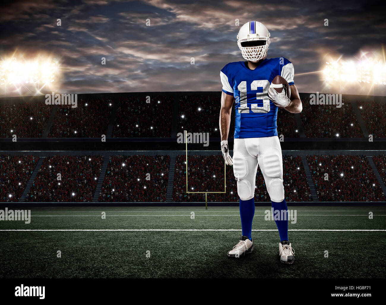Football Player with a blue uniform on a stadium Stock Photo - Alamy