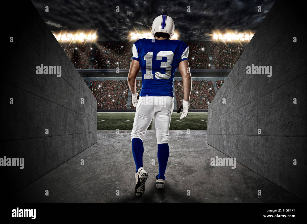 Football Player with a blue uniform walking out of a Stadium tunnel ...