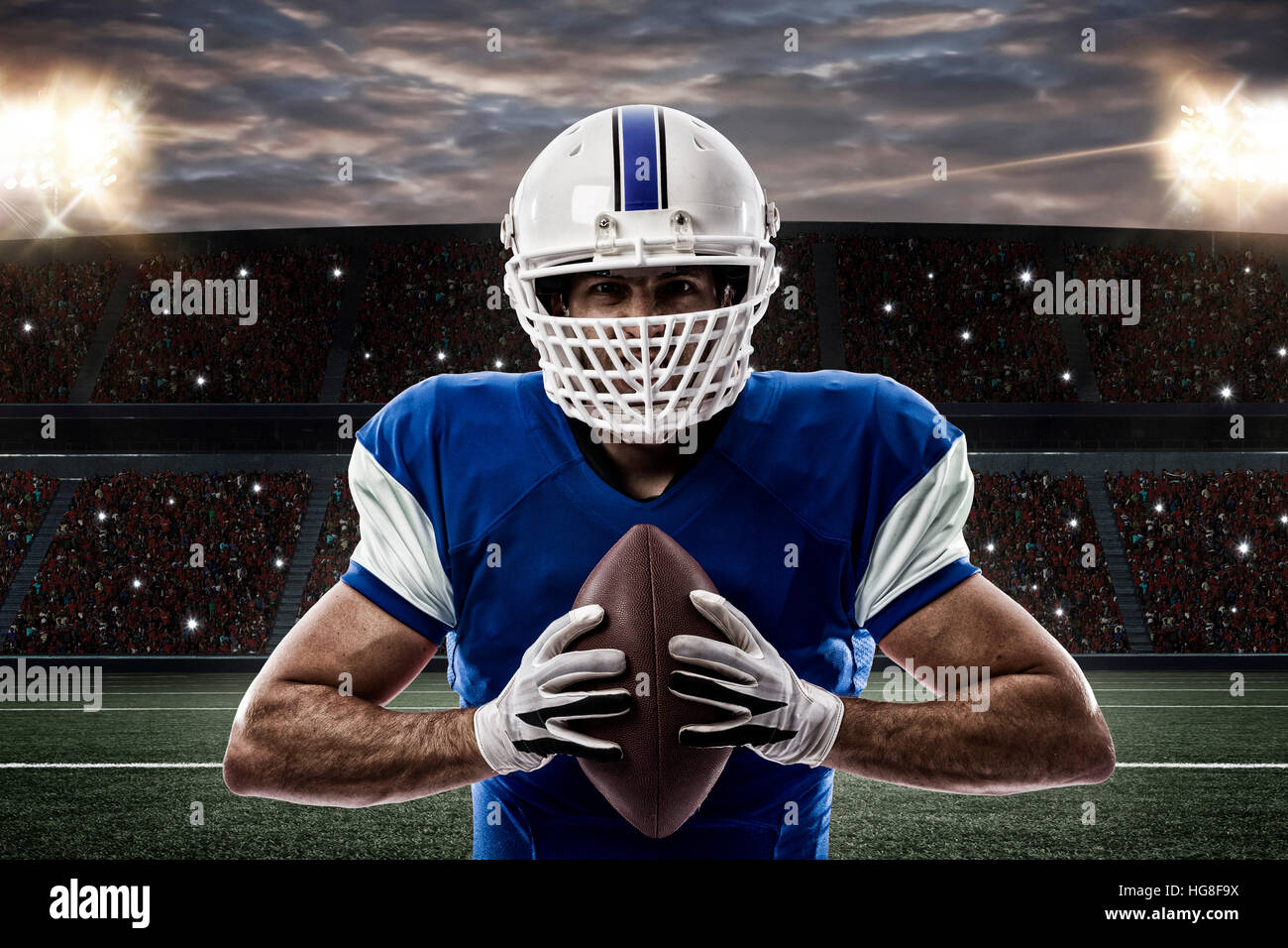 Football Player with a blue uniform on a stadium Stock Photo - Alamy