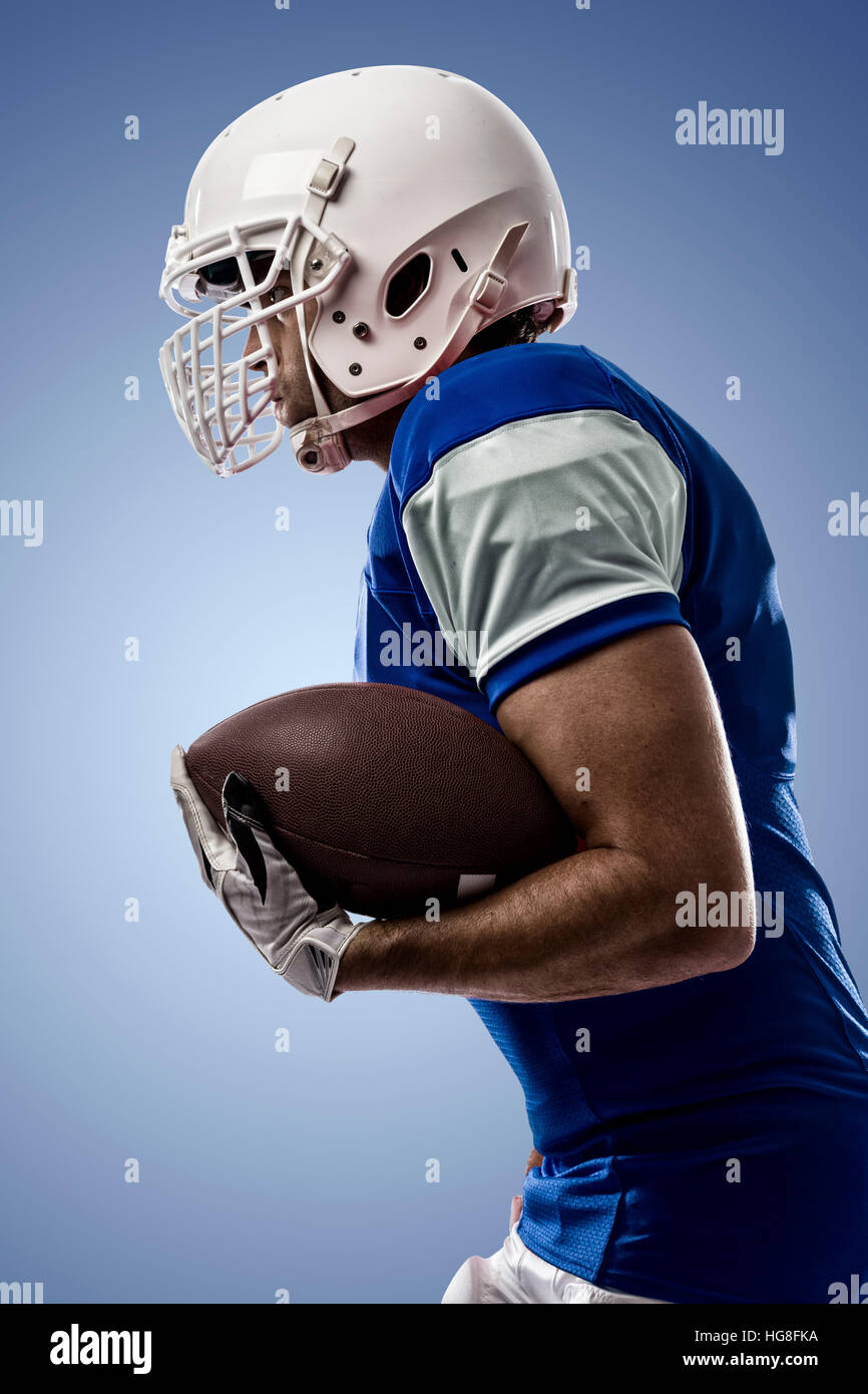 Football Player with a blue uniform Running on a blue background Stock ...