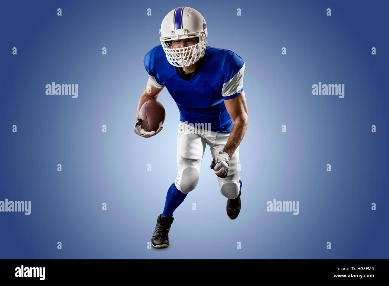 Football Player with a blue uniform Running on a blue background Stock ...