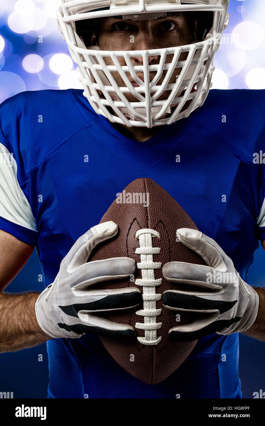 Close up of a Football Player with a blue uniform on a blue lights ...
