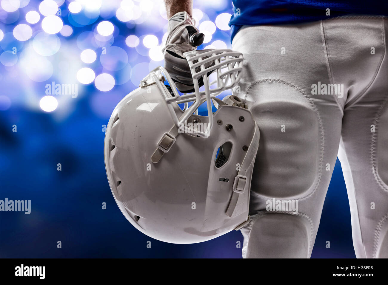 Football Player with a blue uniform on a blue lights background Stock ...