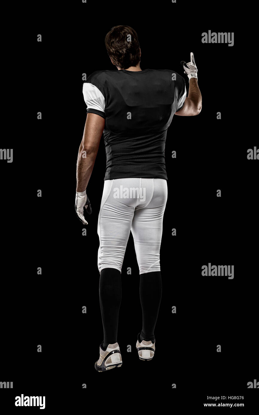 Football Player with a black uniform walking, showing his back on a ...
