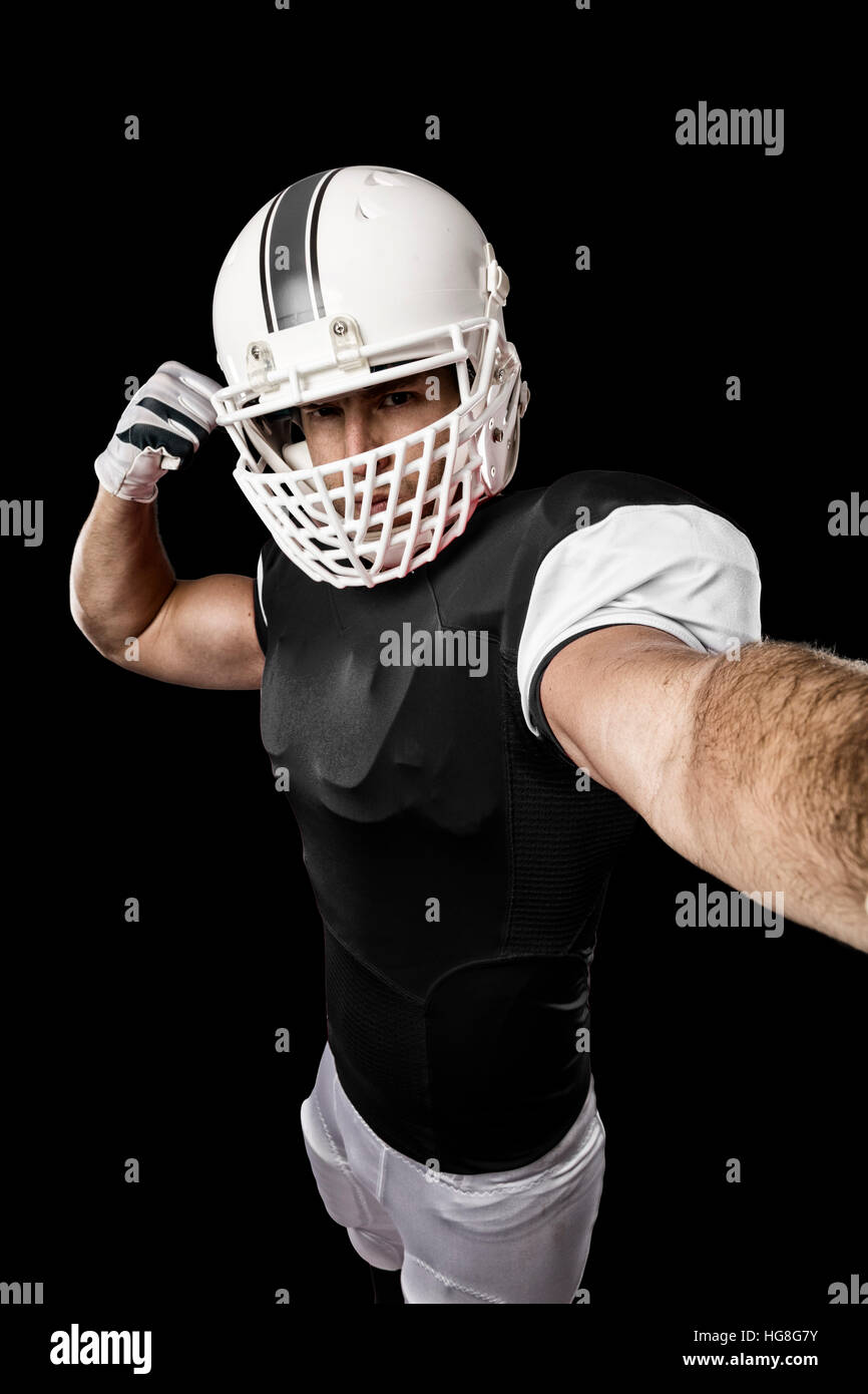 Football Player with a black uniform making a selfie on a black ...