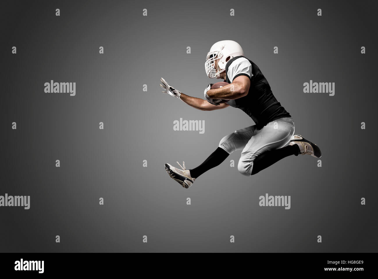 Football Player with a black uniform Running on a black background ...