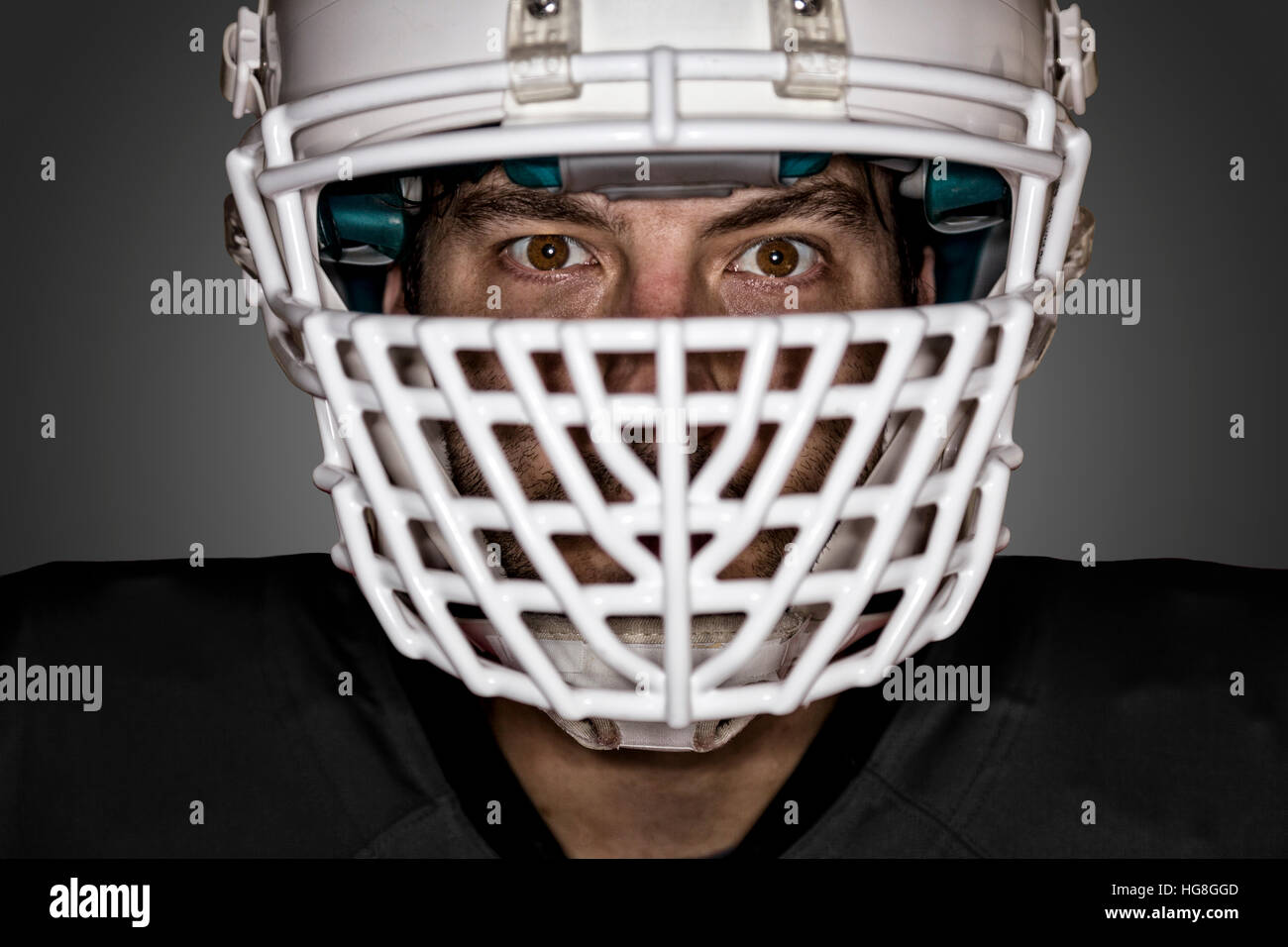 Close up in the eyes of a Football Player with a black uniform on a ...