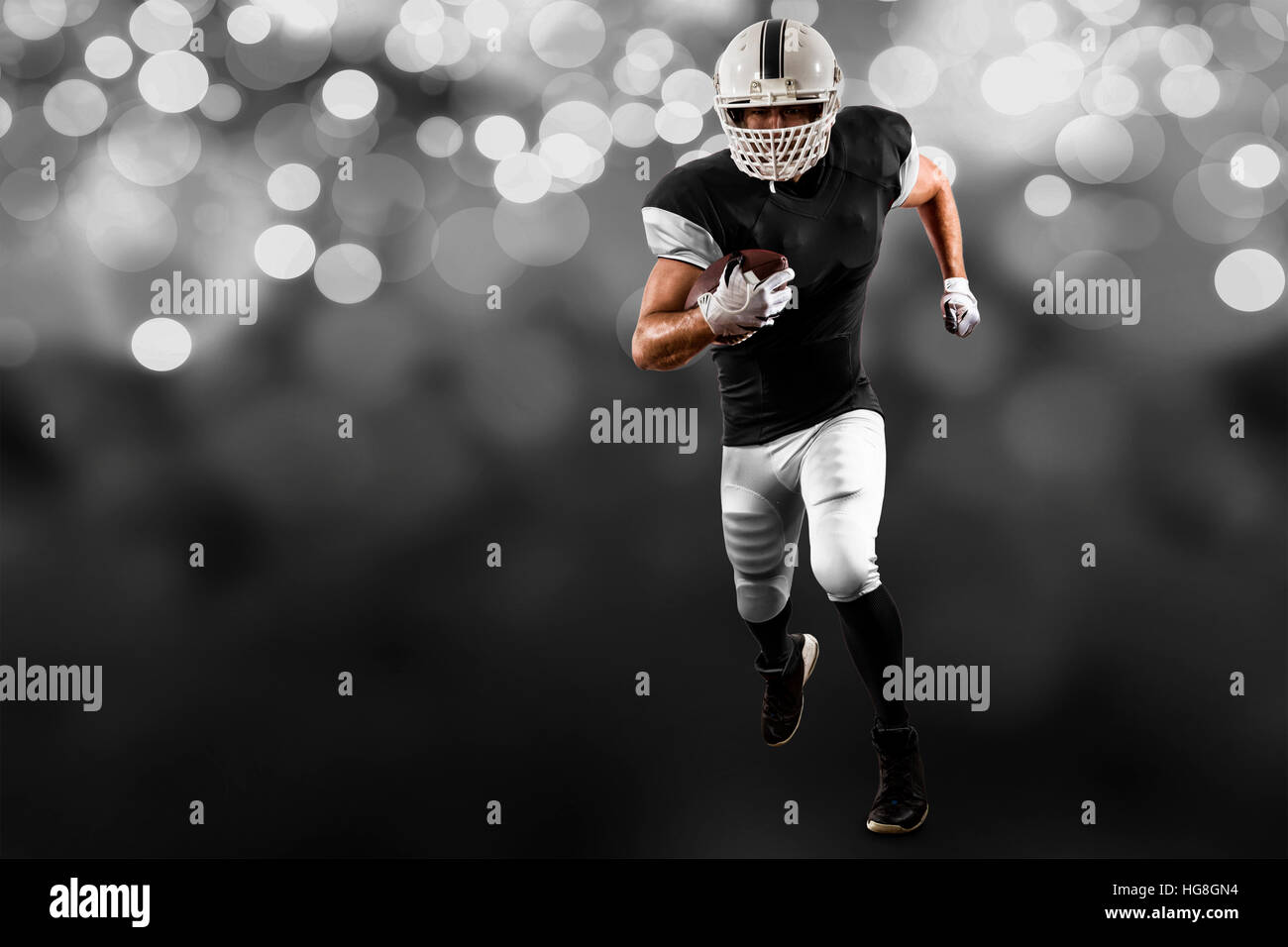 Football Player with a black uniform Running on a black lights ...