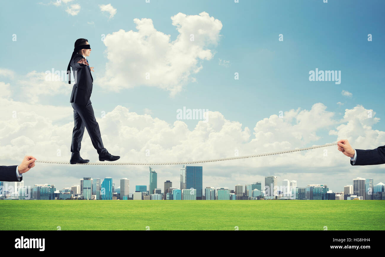 Business concept of risk support and assistance with man balancing on ...