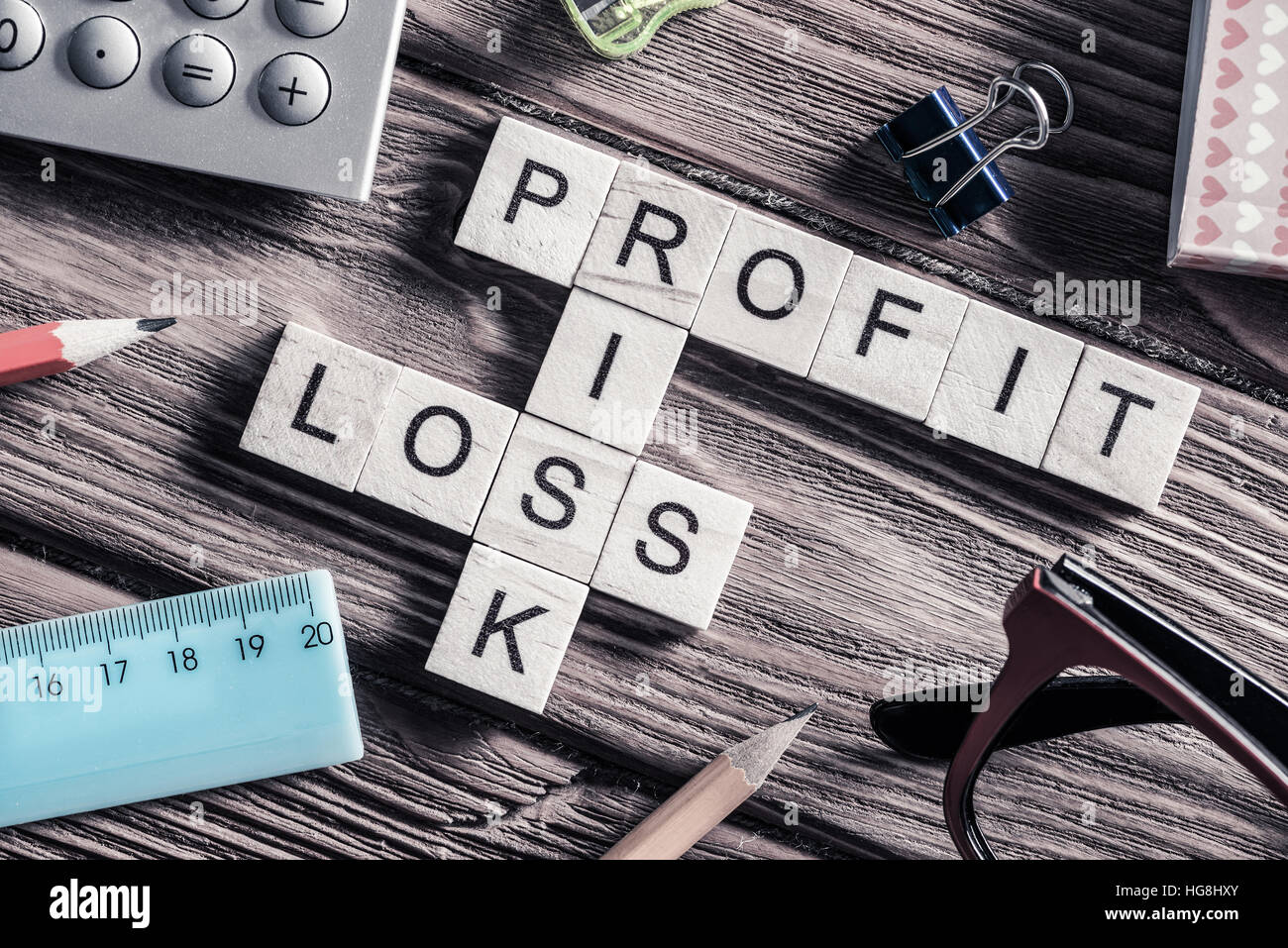 Profit loss and risk words on workplace collected of wooden cube Stock ...