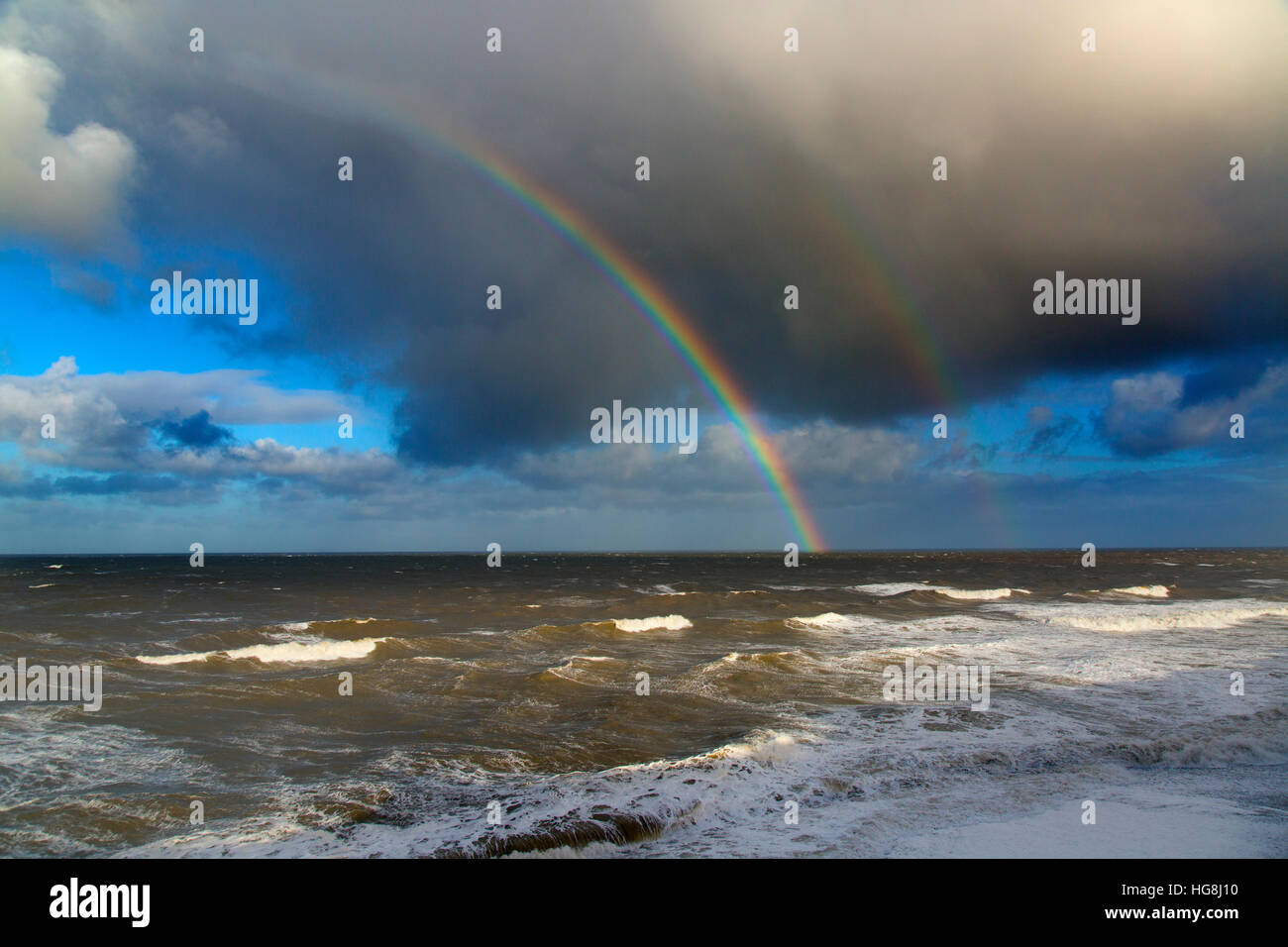 Rainbow and storm clouds at coast hi-res stock photography and images ...