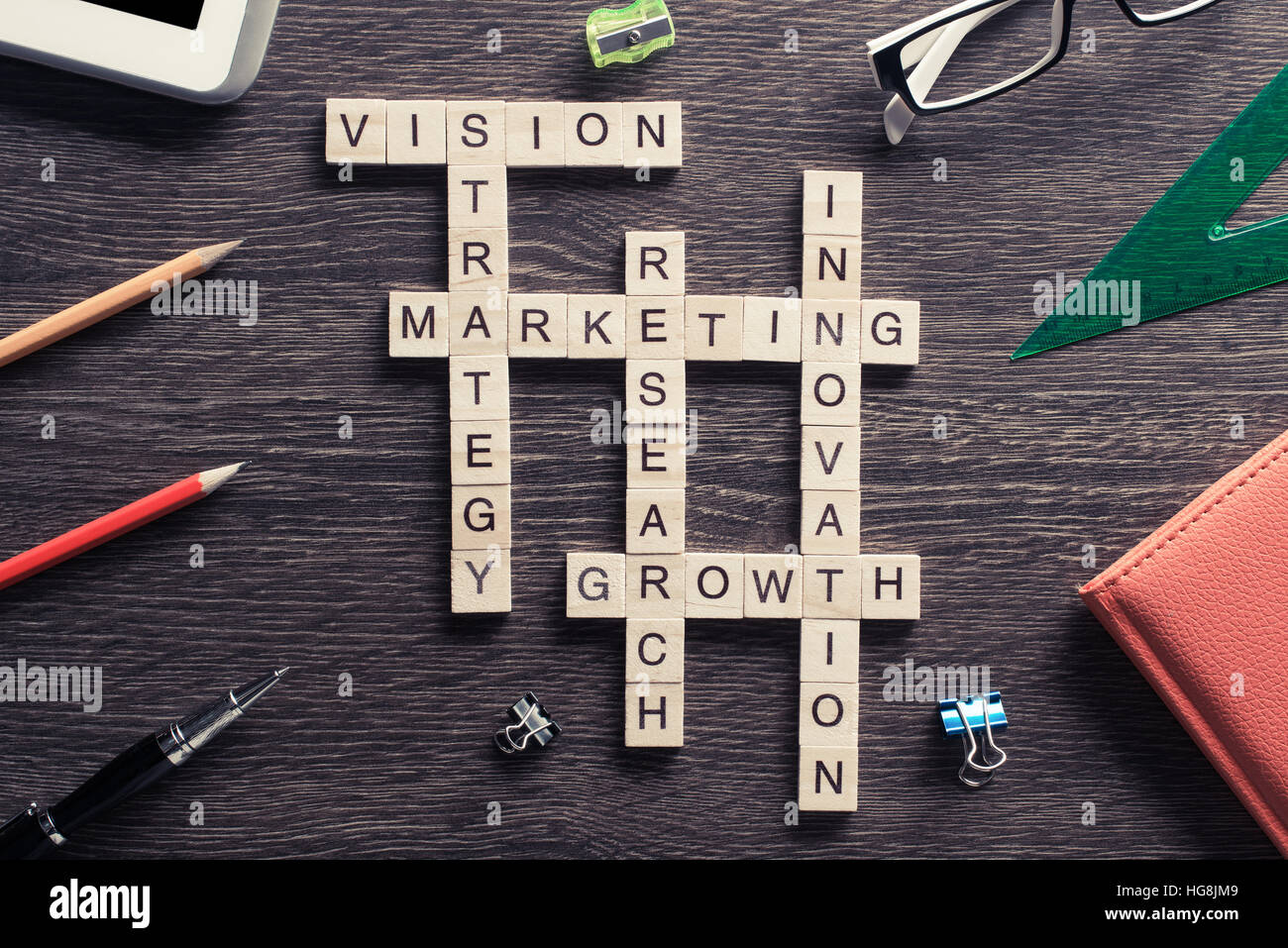 Business workplace with office stuff and wooden cubes making crossword ...