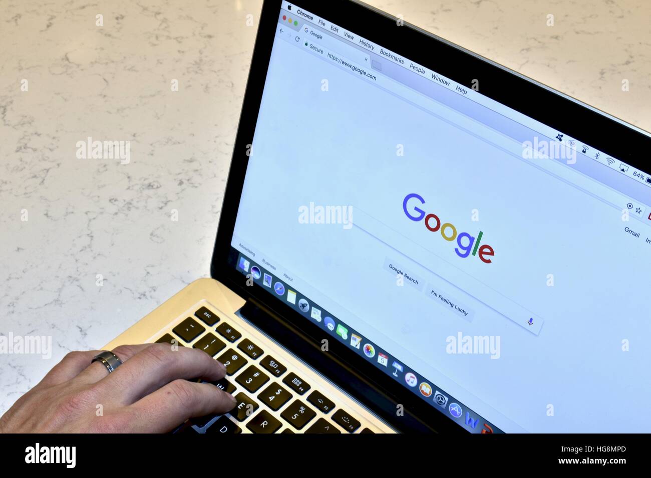 An Apple Macbook Pro with the Google search engine displayed on the ...