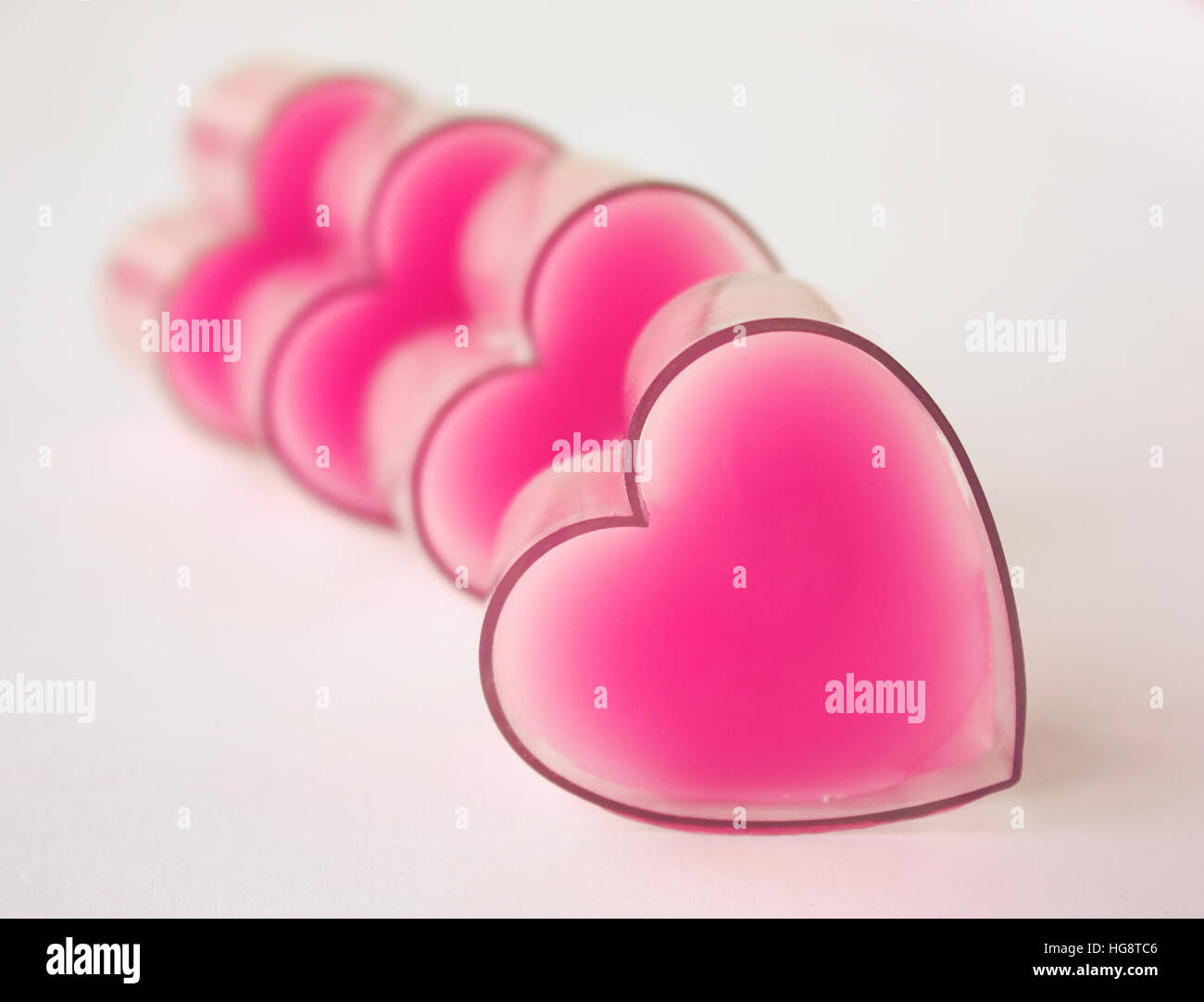 Pink hearts at row on light background. Artistic blur (defocused Stock ...