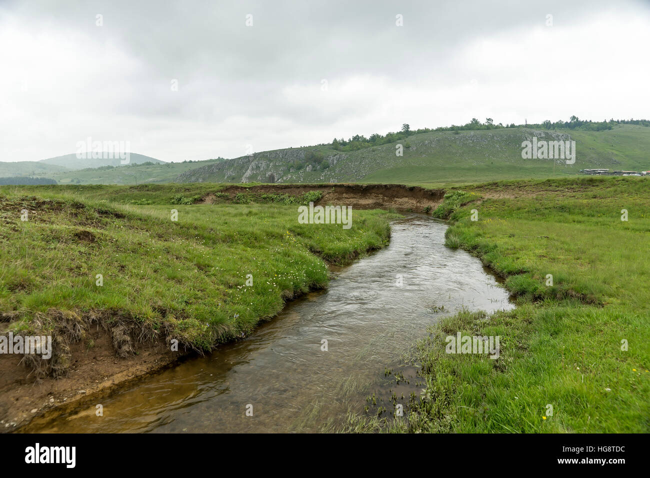 Stream on a meadow in the mountains landscape Stock Photo - Alamy