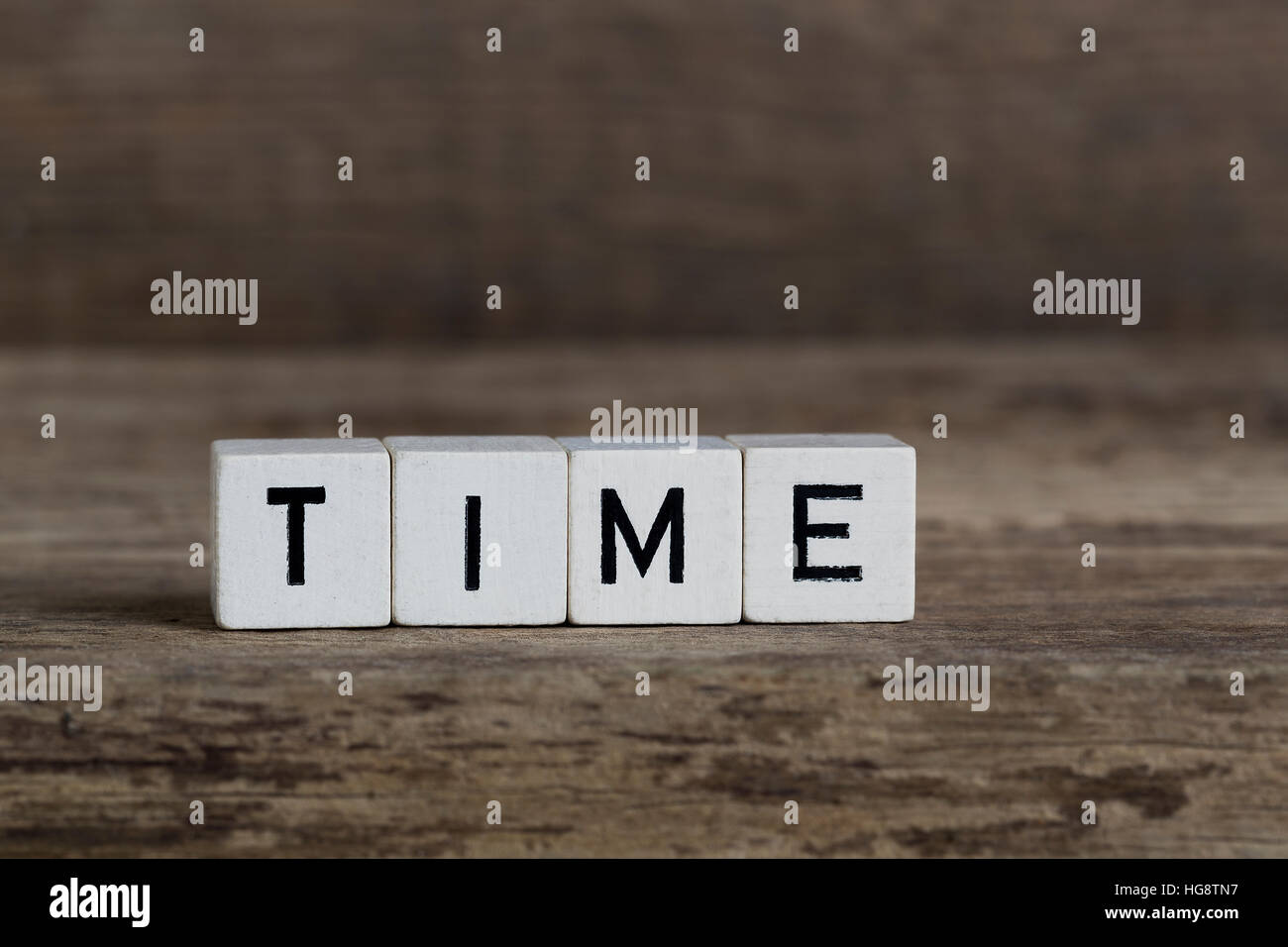 Time, written in cubes on wooden background Stock Photo - Alamy