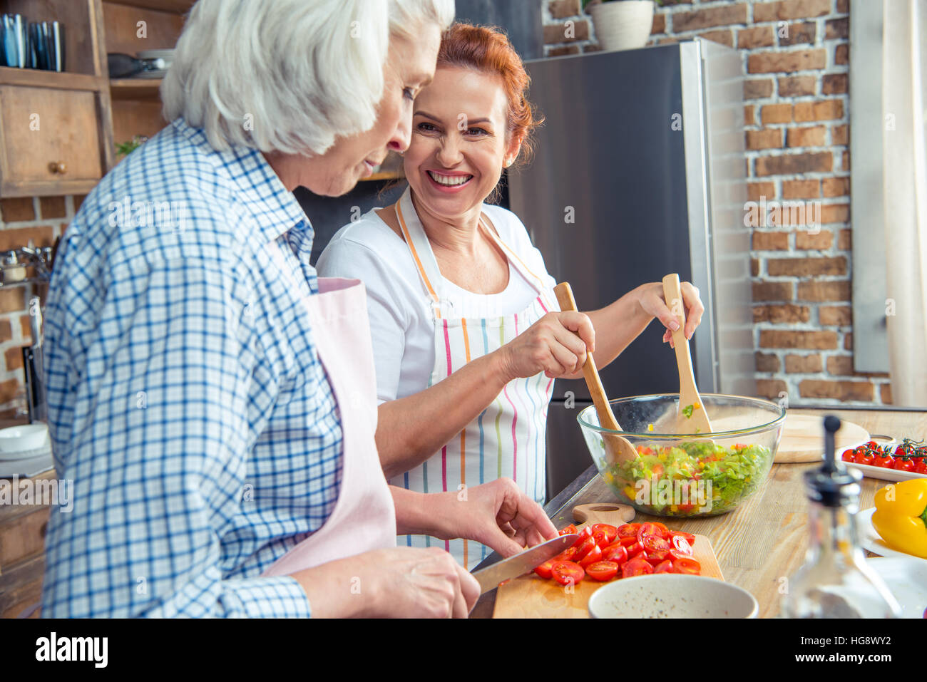 Women cooking and smiling hi-res stock photography and images - Alamy