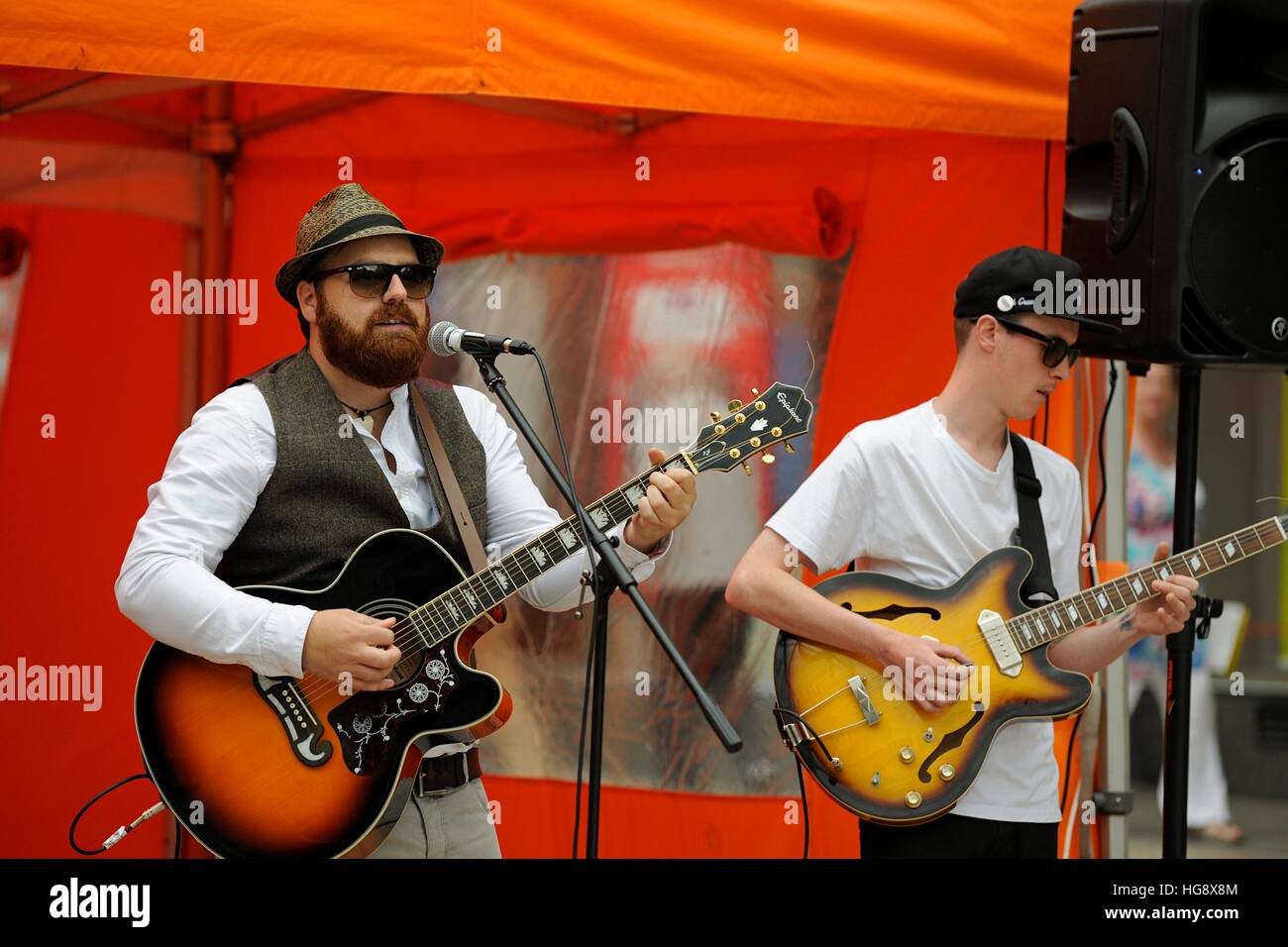 folk rock guitarists on stage playing Epiphone guitars at the Tramlines ...