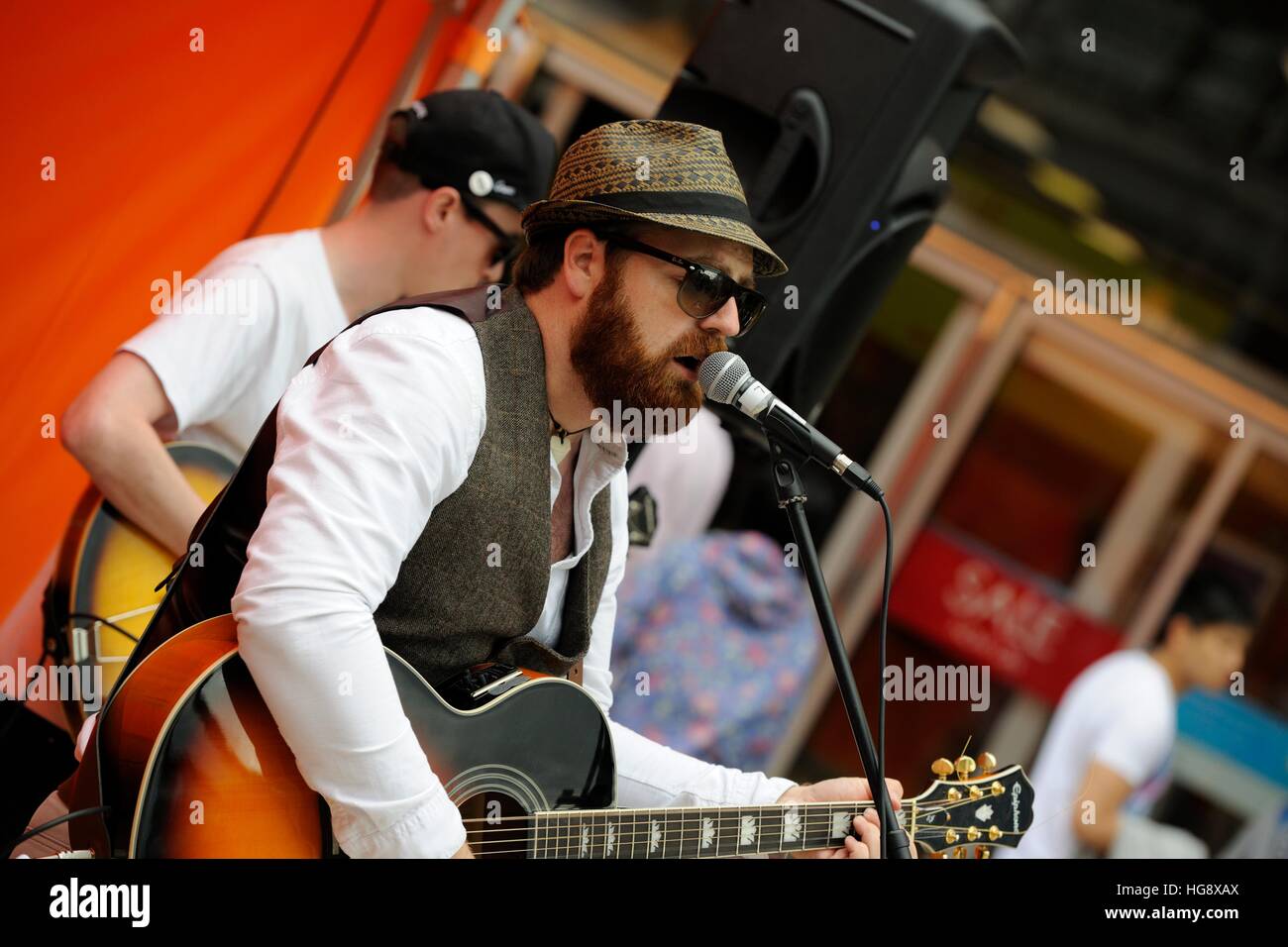 folk rock guitarist on stage playing an Epiphone semi-acoustic at the ...
