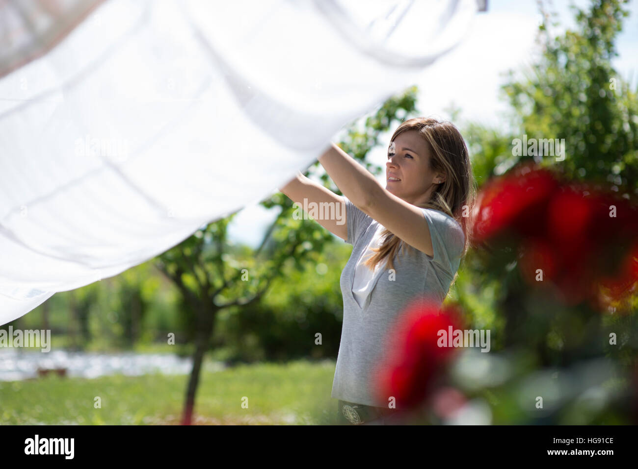 Woman hanging up laundry Stock Photo - Alamy