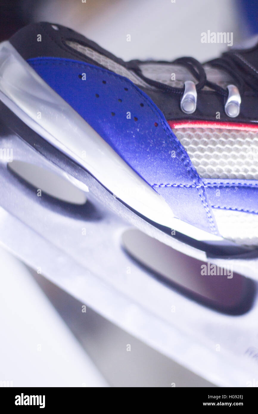 Ice skates in skate store shop window on display on sale for skating on ...