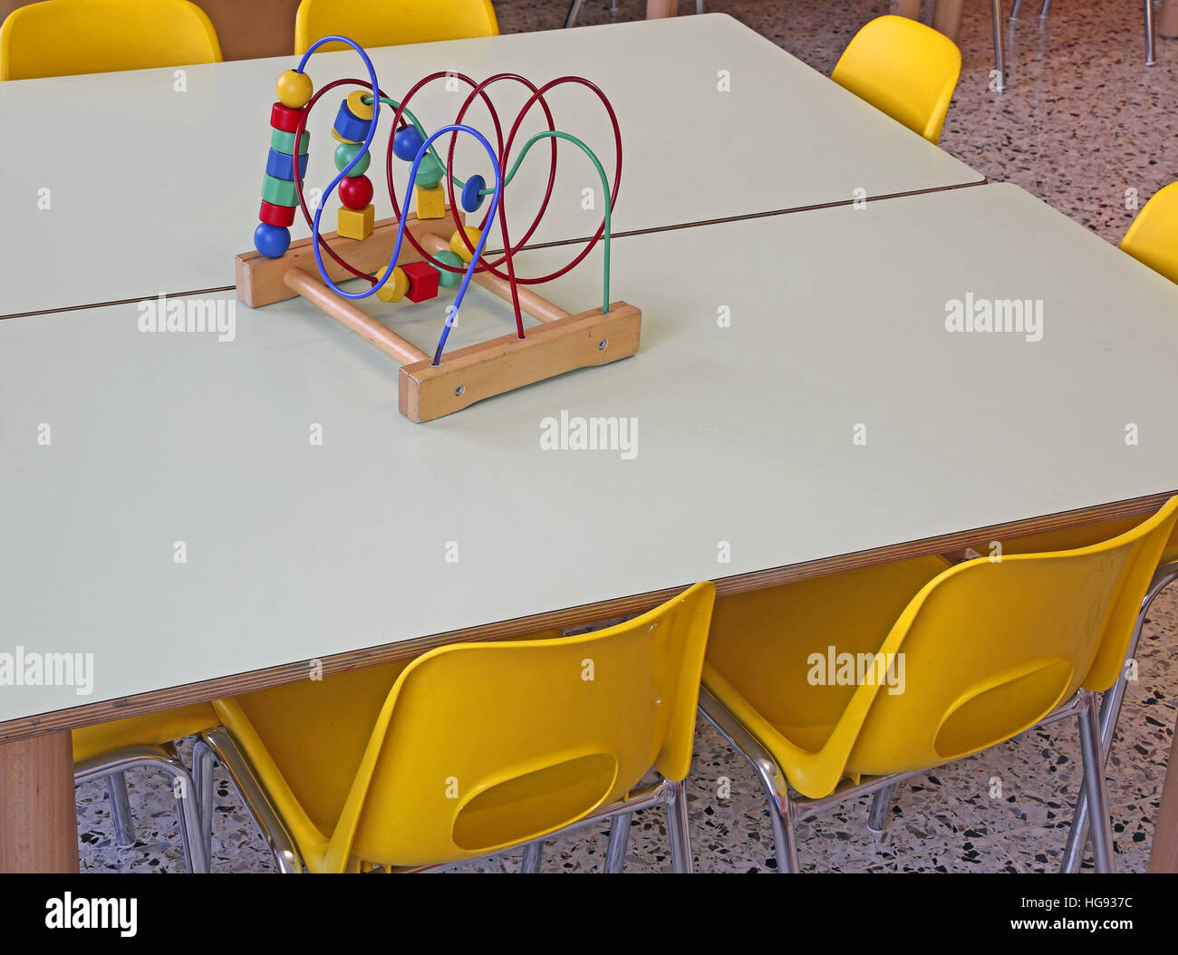 yellow chairs with small benches inside a daycare Stock Photo - Alamy
