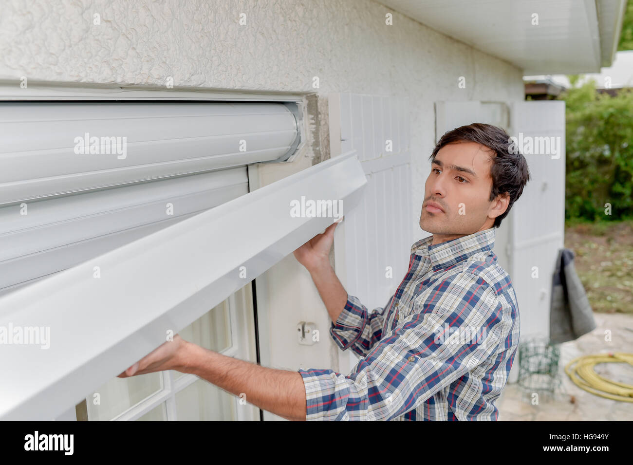 Installing window shutter Stock Photo - Alamy